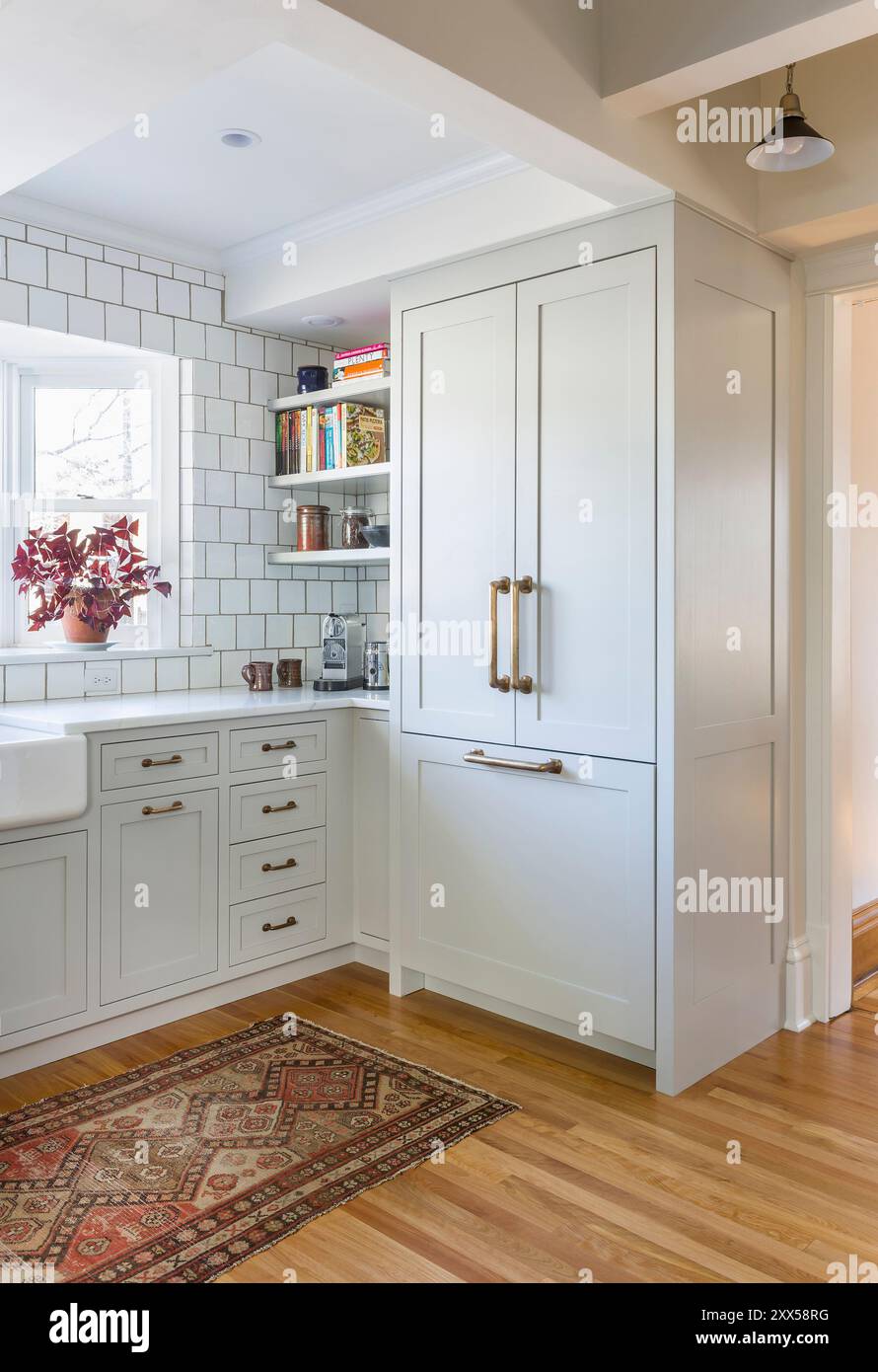 Corner of kitchen showing refrigerator and built-in shelves Stock Photo ...