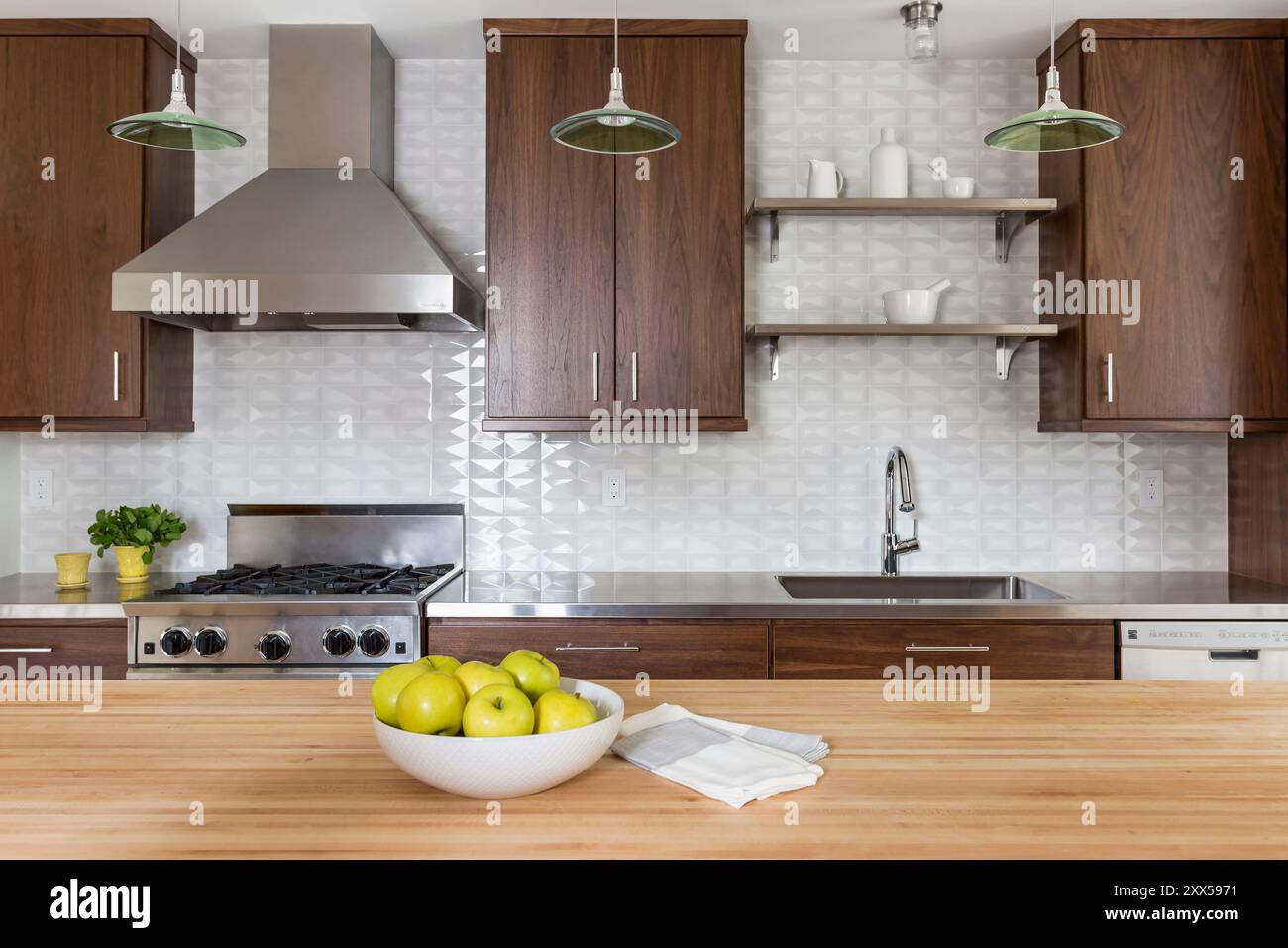 Butcher block countertop with dark wood kitchen cabinets and white tile ...