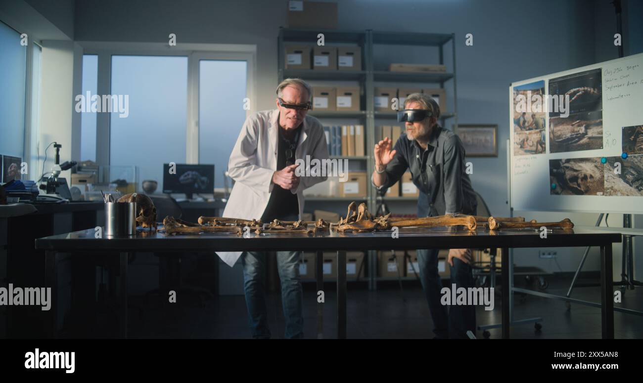 Two archaeologists in VR headsets study remains of ancient extinct ...