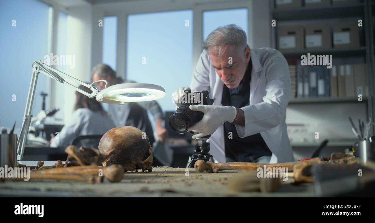 Senior archaeologist takes photo of fossil remains of prehistoric human ...