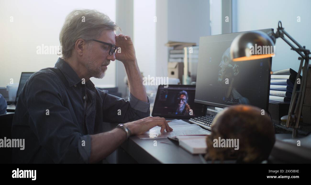 Mature archaeologist studies fossil skull, uses tablet computer and PC ...