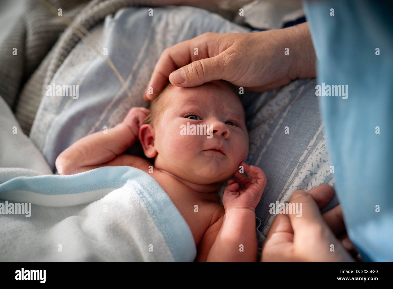 Baby Looking Up at Mother in a Tender Moment Stock Photo - Alamy