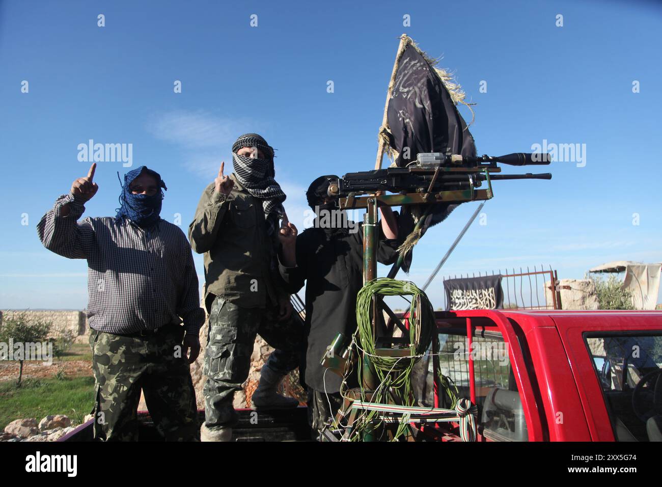 Three an-Nusra Front fighters holding an electric sniper machine gun ...