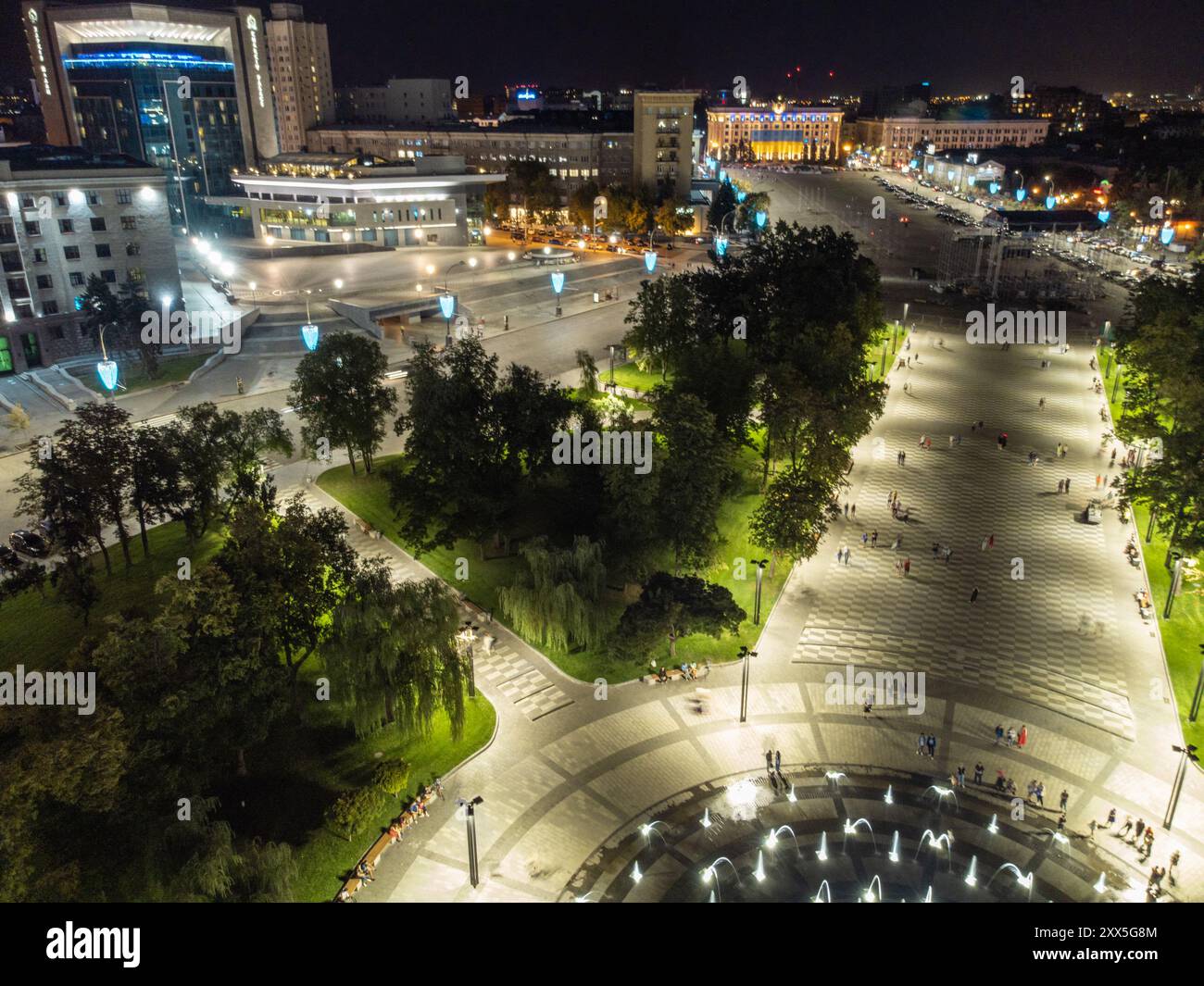Aerial night cityscape of Freedom Square with fountain and hotel ...