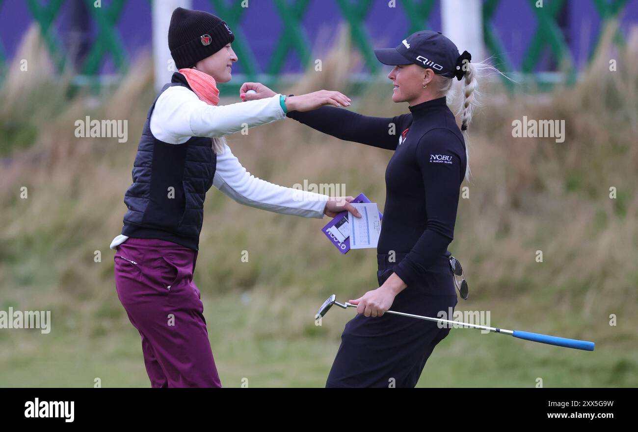 Charley Hull hugs Nelly Korda on the 18th during day one of the 2024 AIG Women's Open at St ...