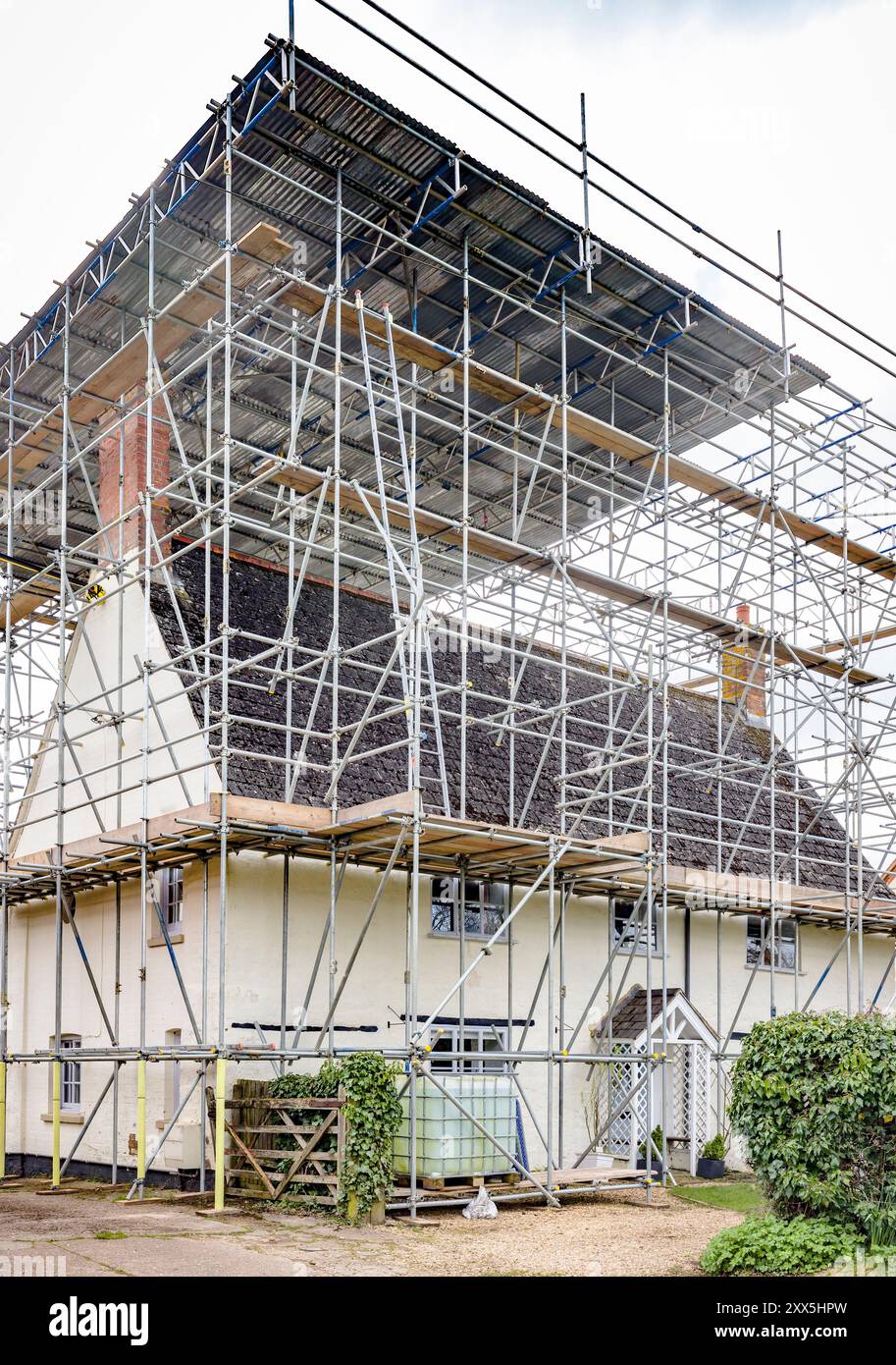 Temporary roof canopy or tin hat (roof scaffolding) over a UK house ...