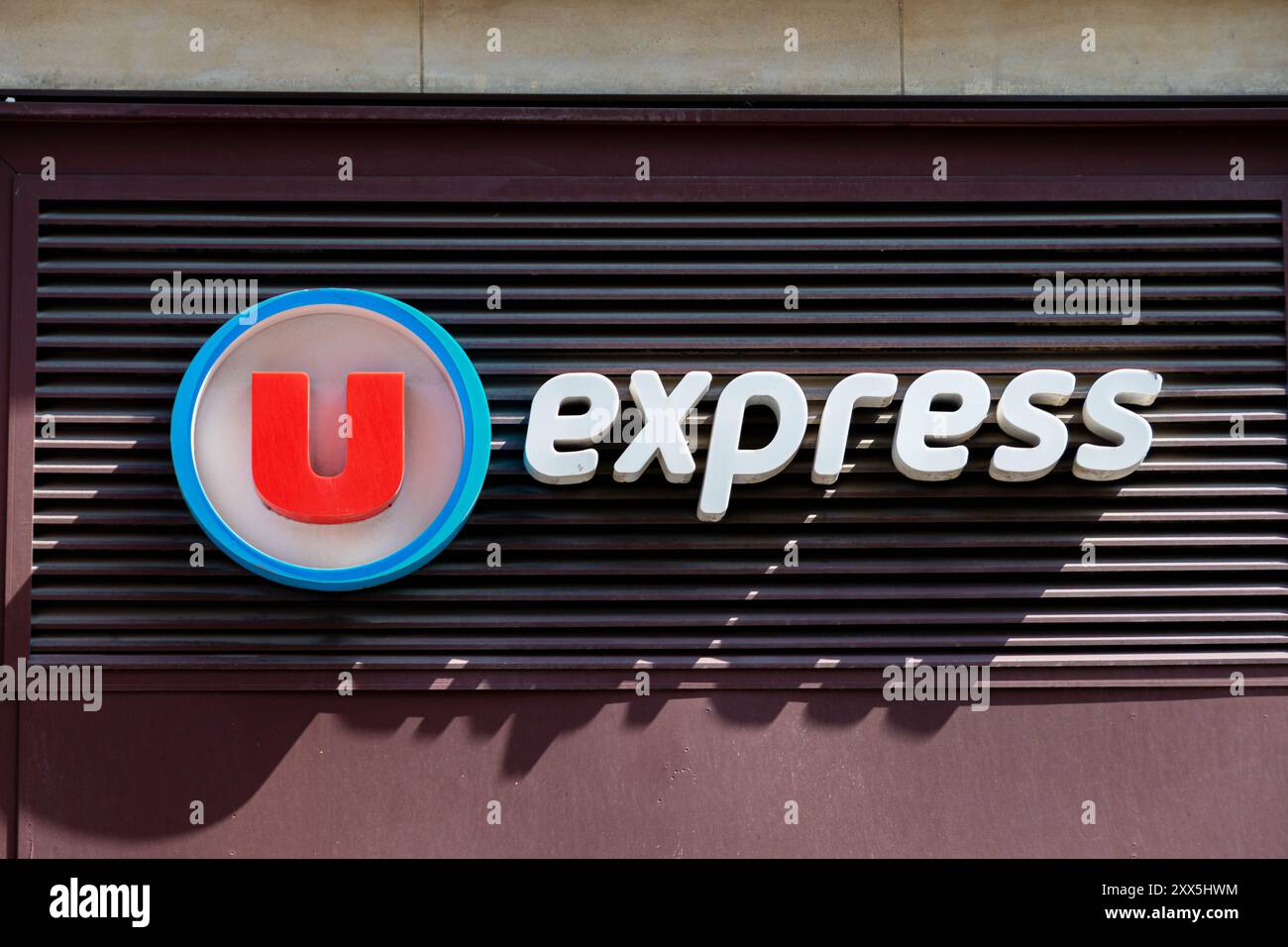 Sign and logo of a U Express supermarket. U Express is a brand of ...