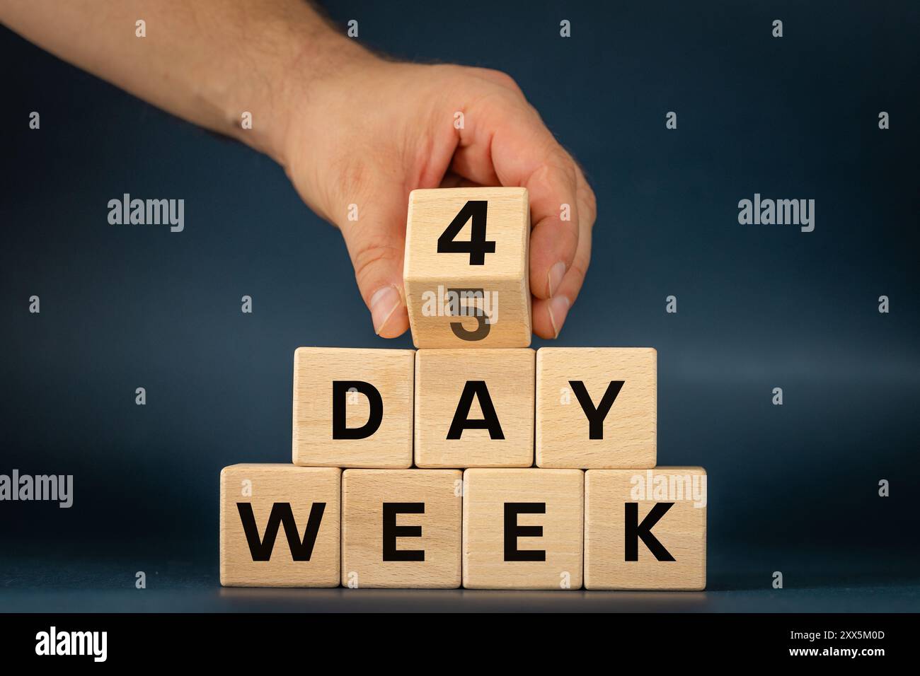 4 day week, Business concept. Hand turning wooden cube from 5 to 4 ...