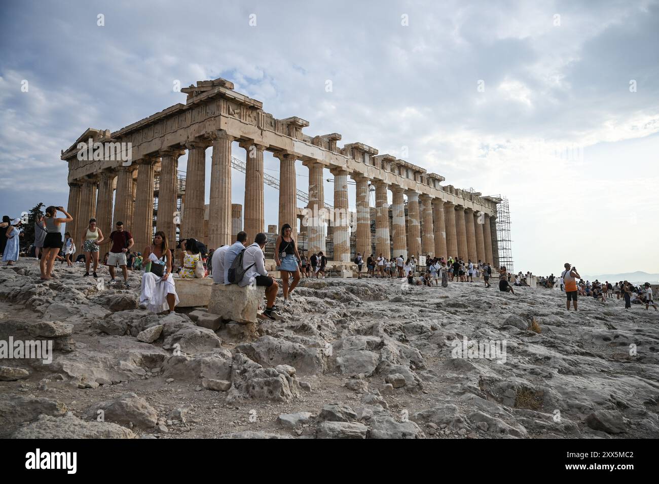 Tourists visit the Parthenon Temple in Acropolis. Overtourism in Greece ...