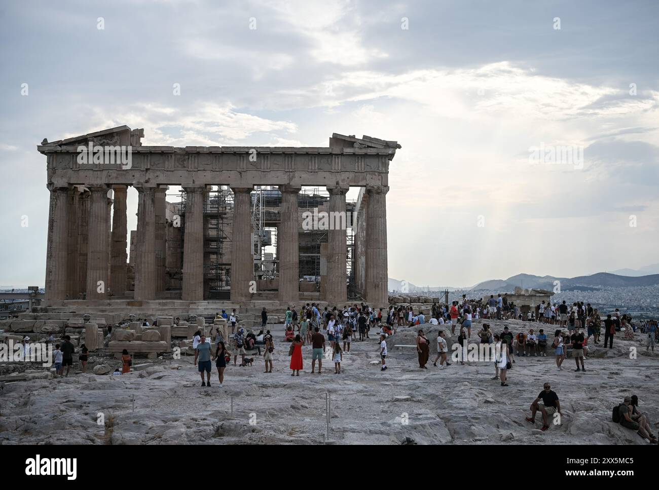 Tourists visit the Parthenon Temple in Acropolis. Overtourism in Greece is welcoming more ...