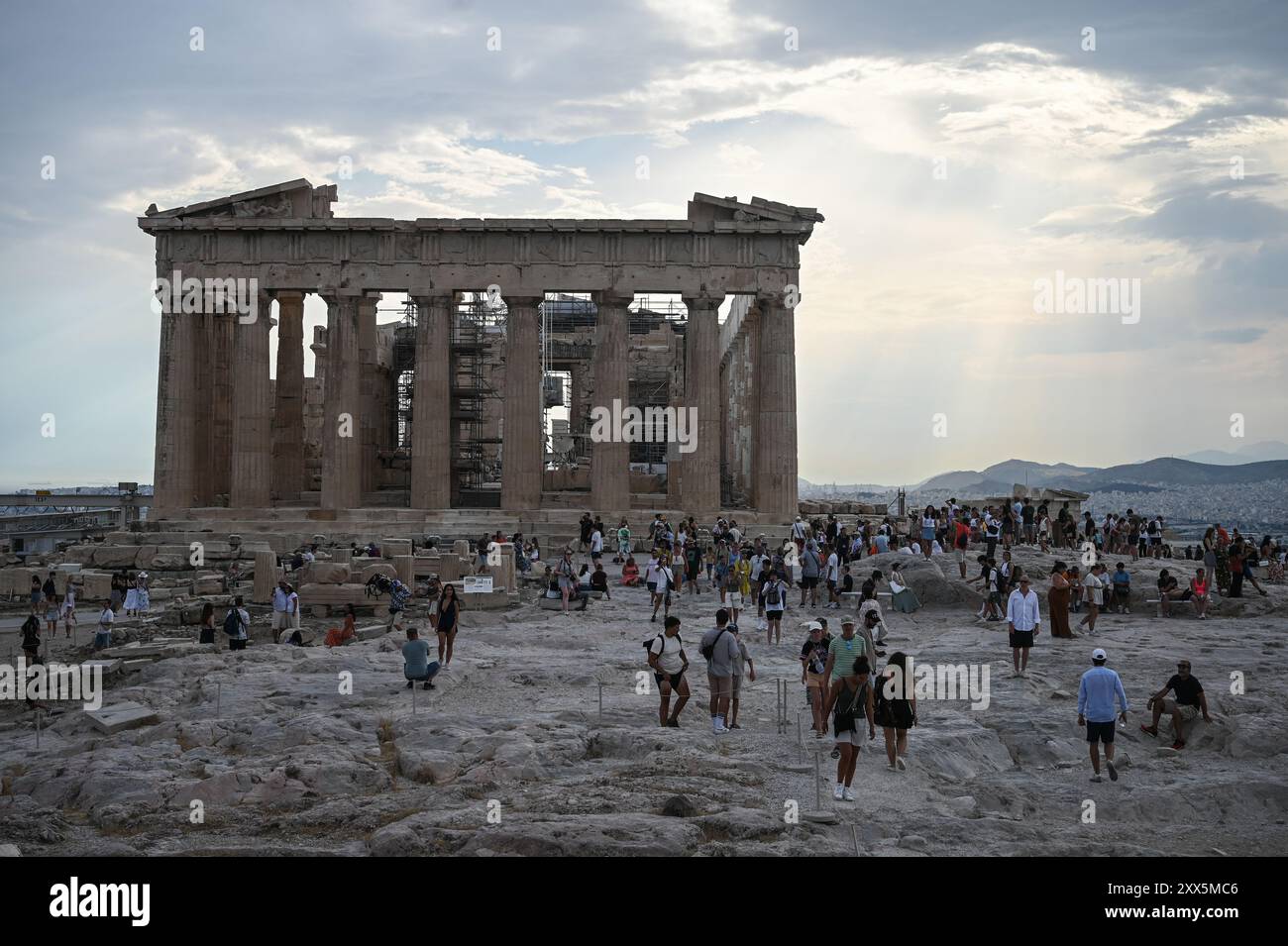 Tourists visit the Parthenon Temple in Acropolis. Overtourism in Greece ...