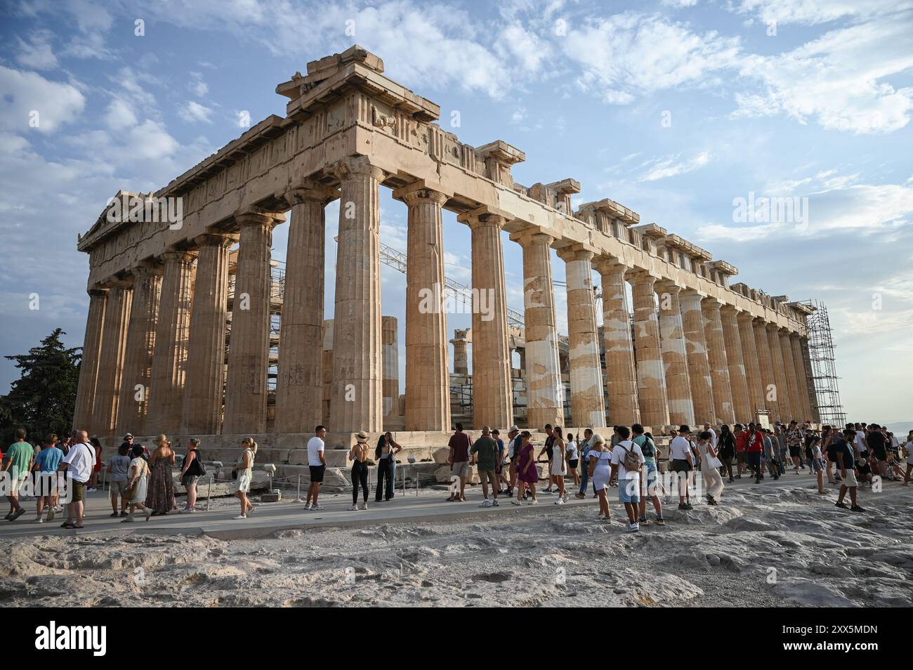 Tourists visit the Parthenon Temple in Acropolis. Overtourism in Greece is welcoming more ...