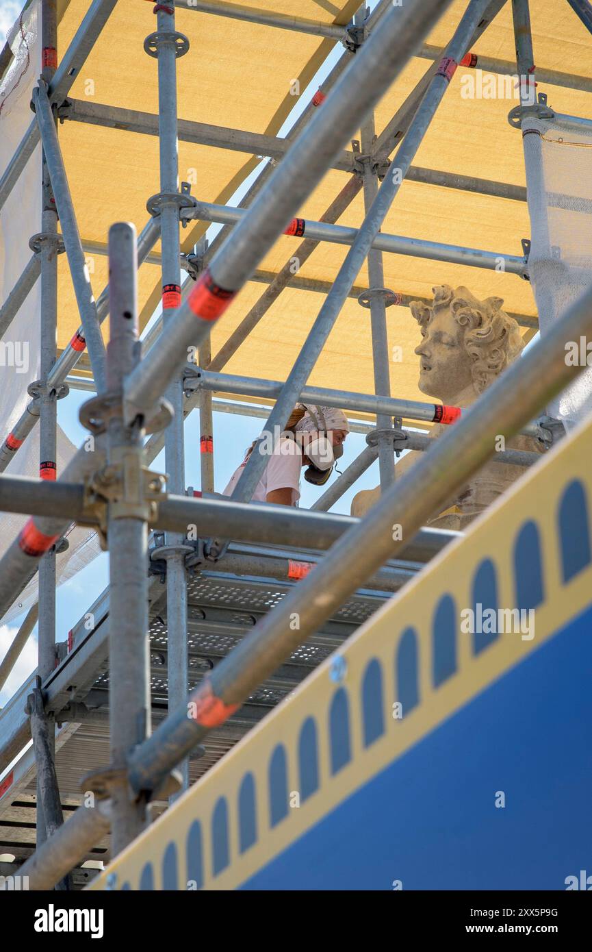 Rome, Italy. 21st Aug, 2024. A worker working to restore one of the ...