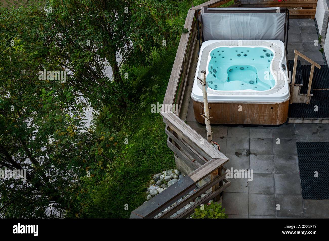 White hot tub on outdoor terrace Stock Photo - Alamy
