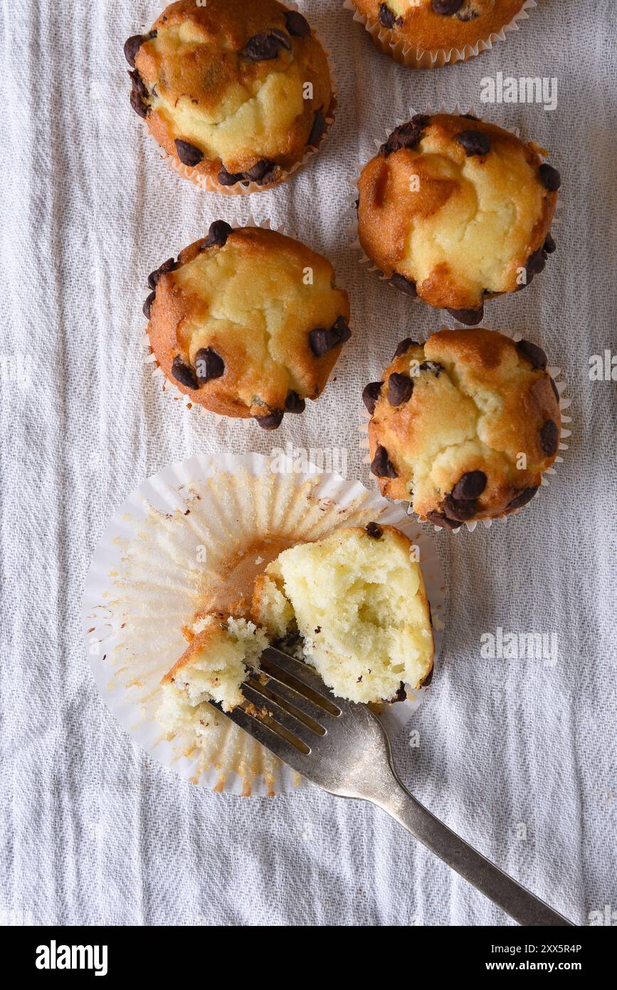 Overhead view of a group of mini chocolate chip muffins on a kitchen ...