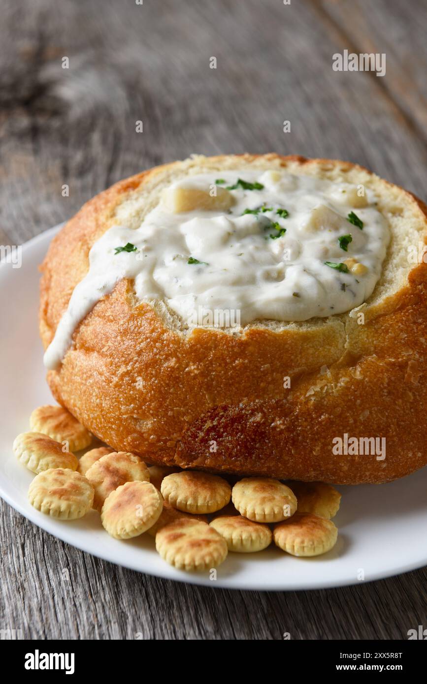 Closeup vertical of New England Style Clam Chowder in a bread bowl ...