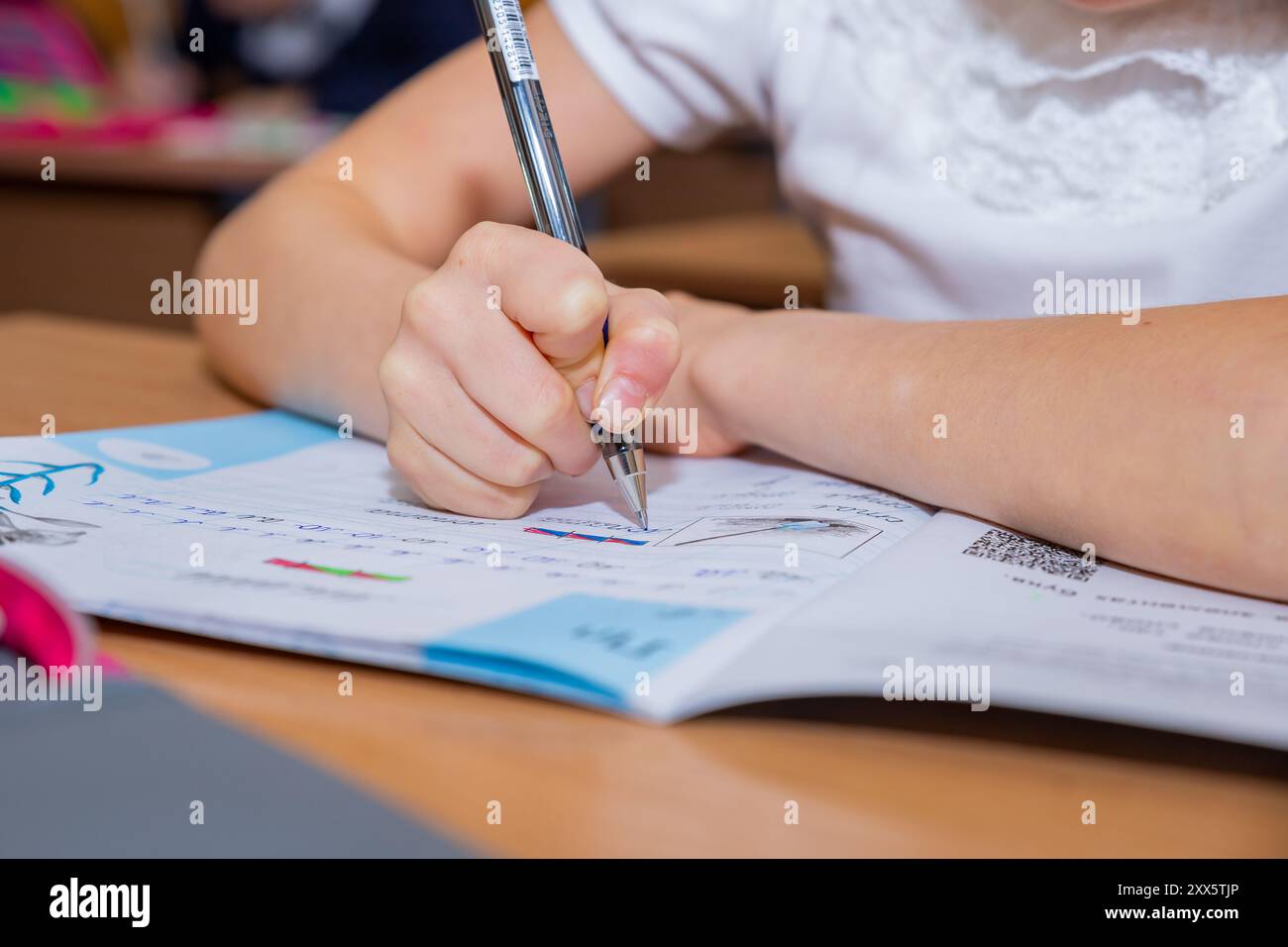 Close-up cropped shot of unrecognizable pupil boy studying at home ...