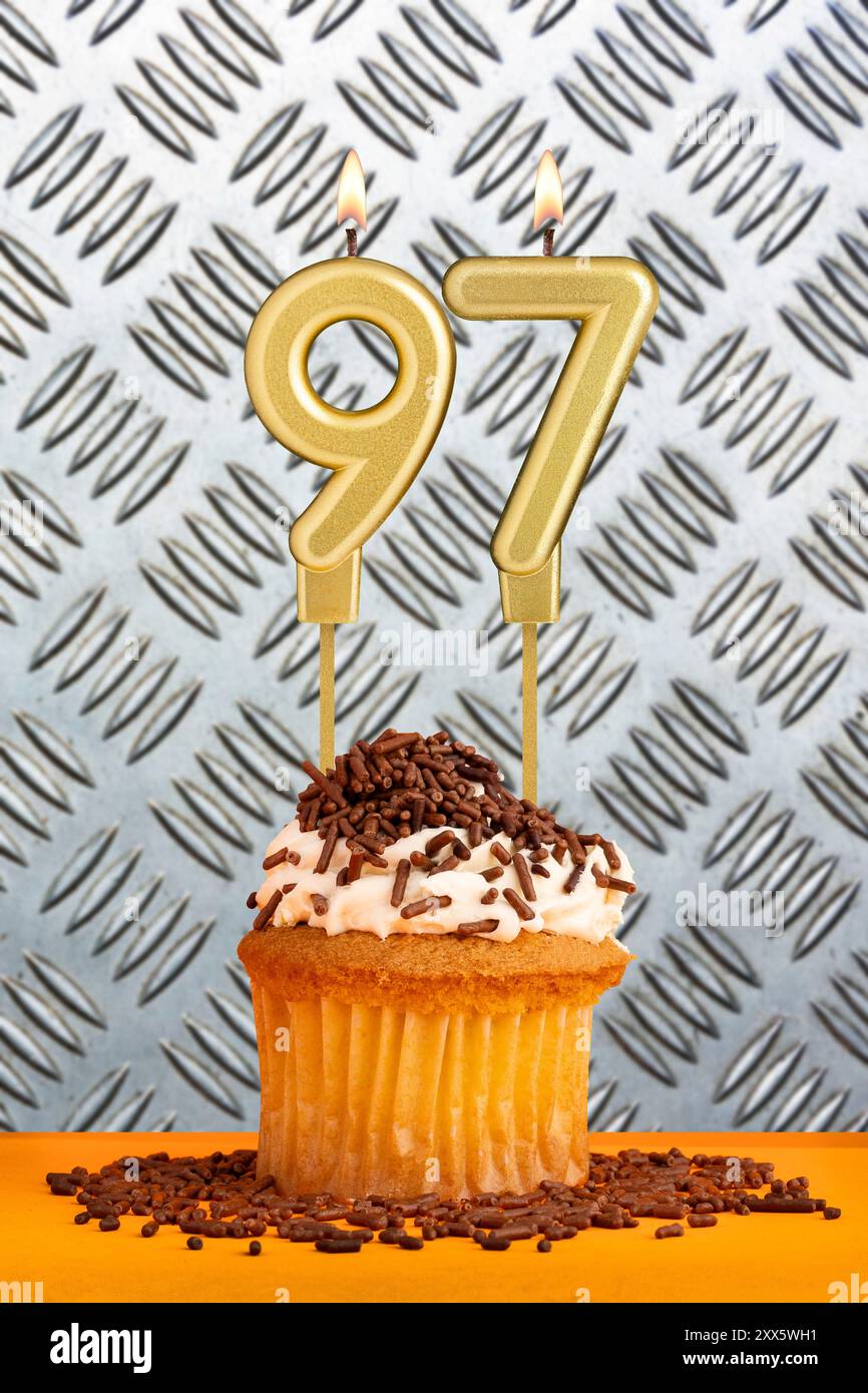 Chocolate cupcake with candle number 97 - Birthday on industrial ...
