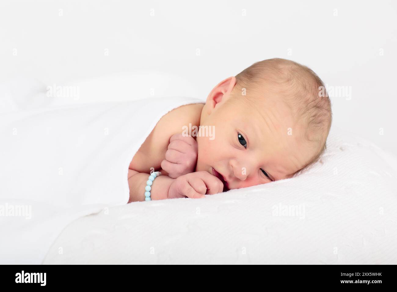 Newborn baby in hospital room. New born child in wooden co-sleeper crib ...