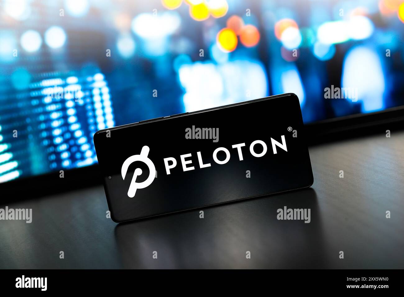 In this photo illustration, the Peloton Interactive, Inc. logo is ...
