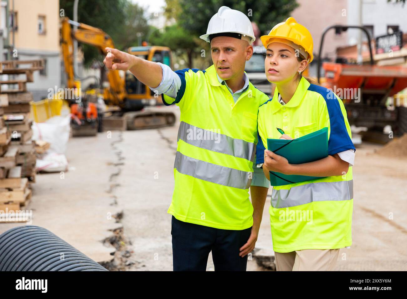 Engineers discussing in construction plant Stock Photo - Alamy