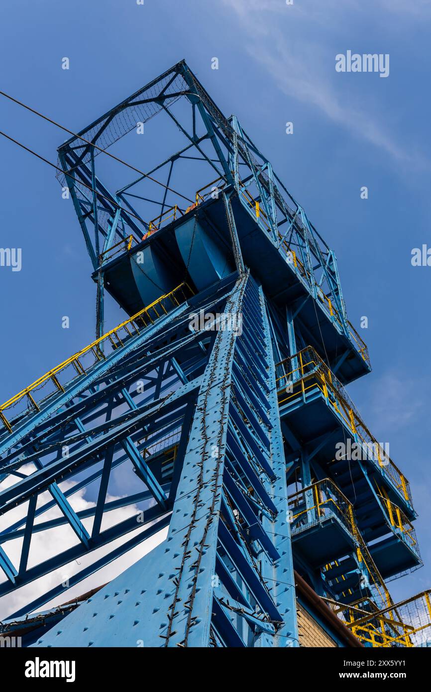 Blue coal mine shaft against a blue sky with delicate clouds. Reduction ...