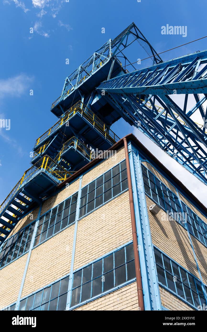 Blue coal mine shaft against a blue sky with delicate clouds. Reduction ...