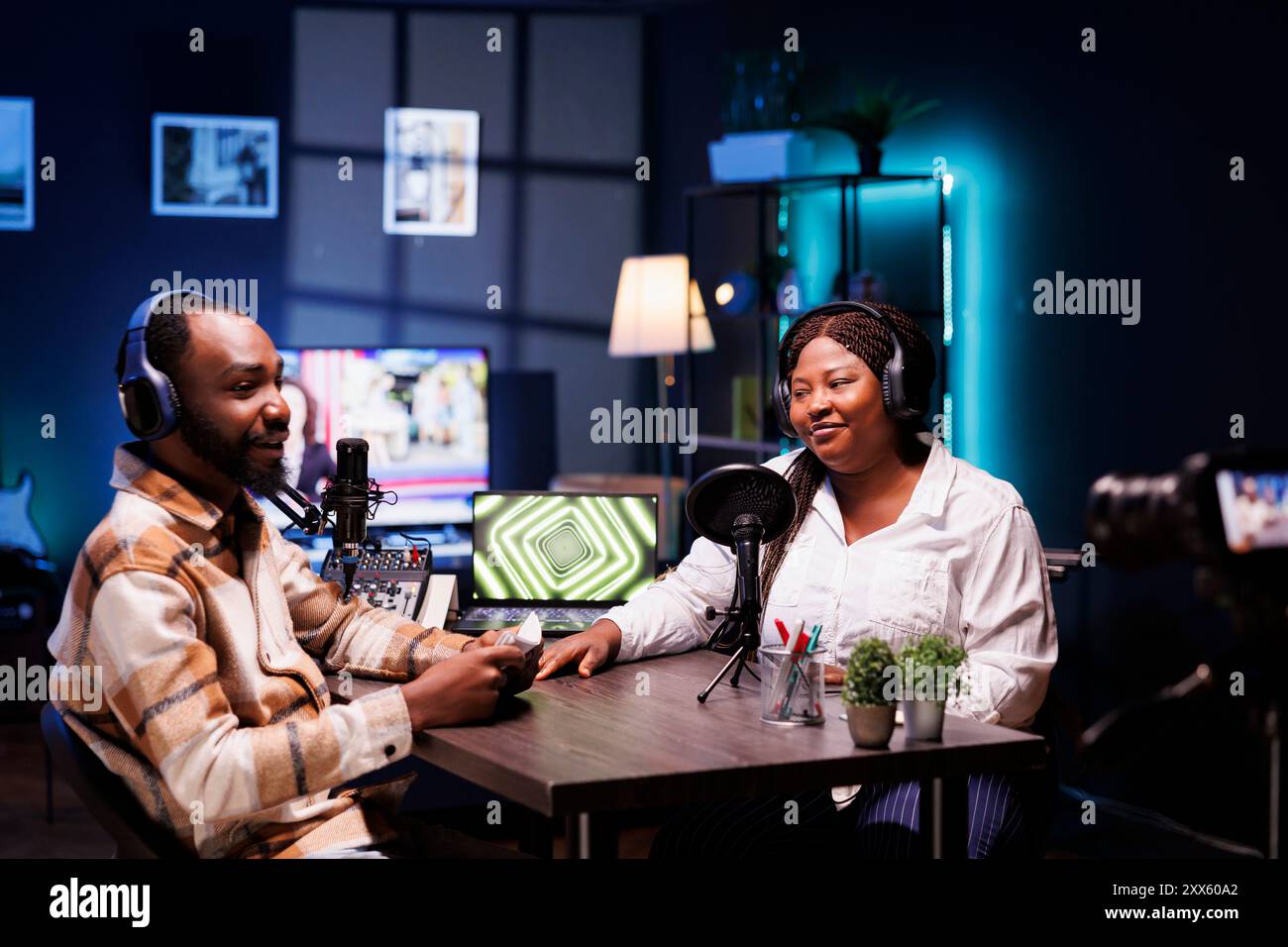 Cheerful media stars recording a podcast in home studio with ...