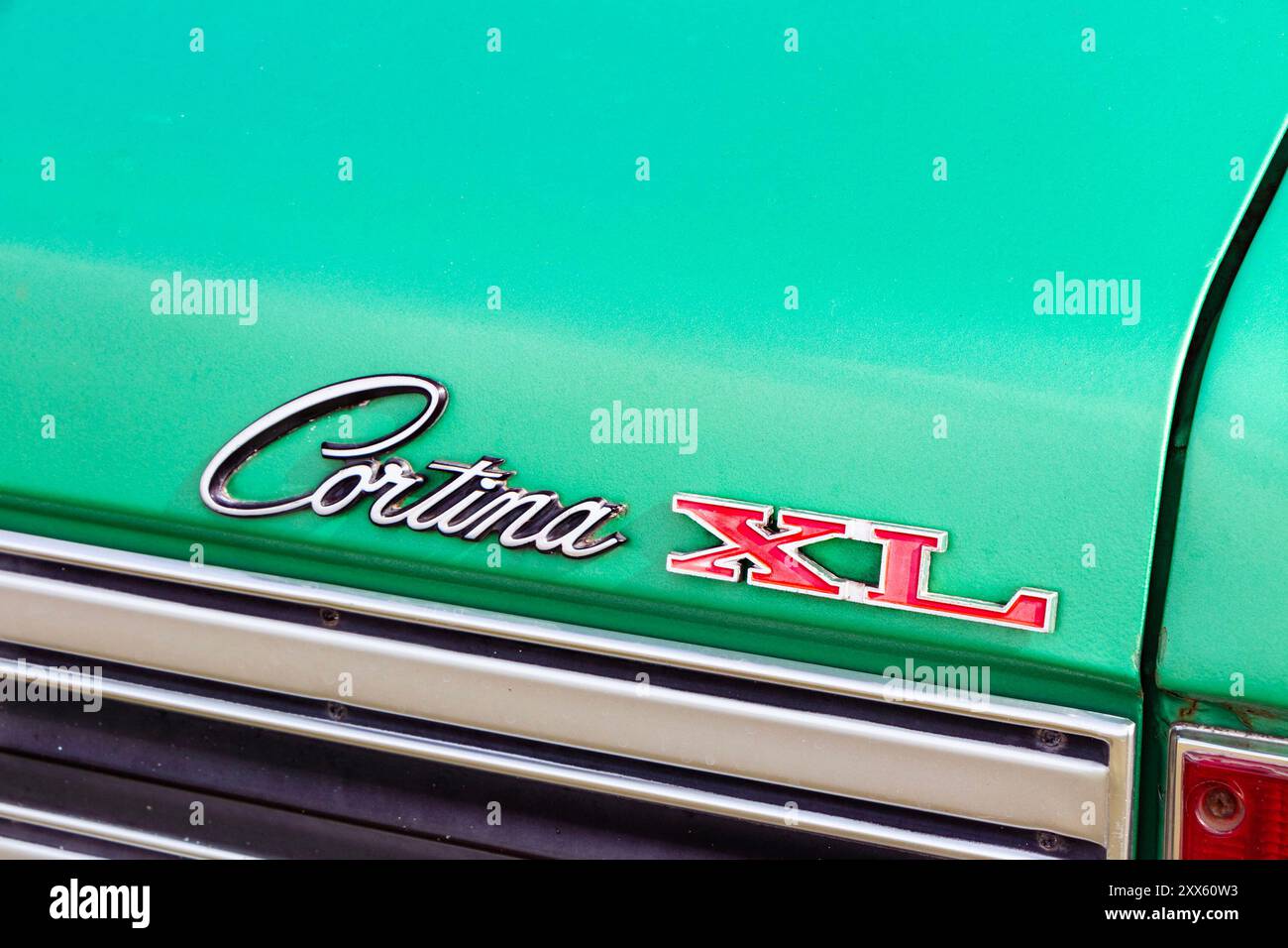 closeup vintage classic chrome car boot badge on green ford cortina Mk3 ...