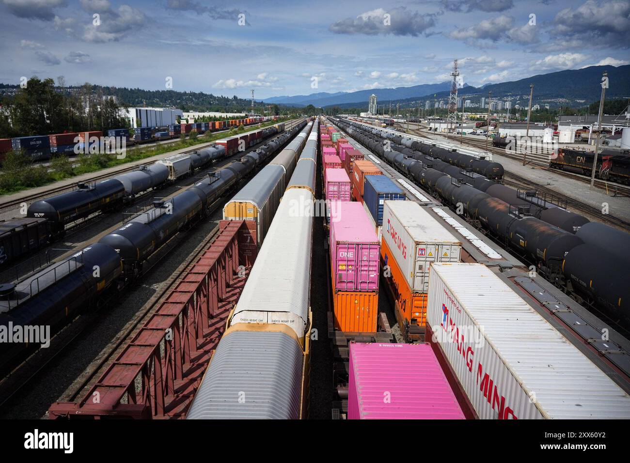 Port Coquitlam, Canada. 19th Aug, 2024. Shipping containers and tanker ...