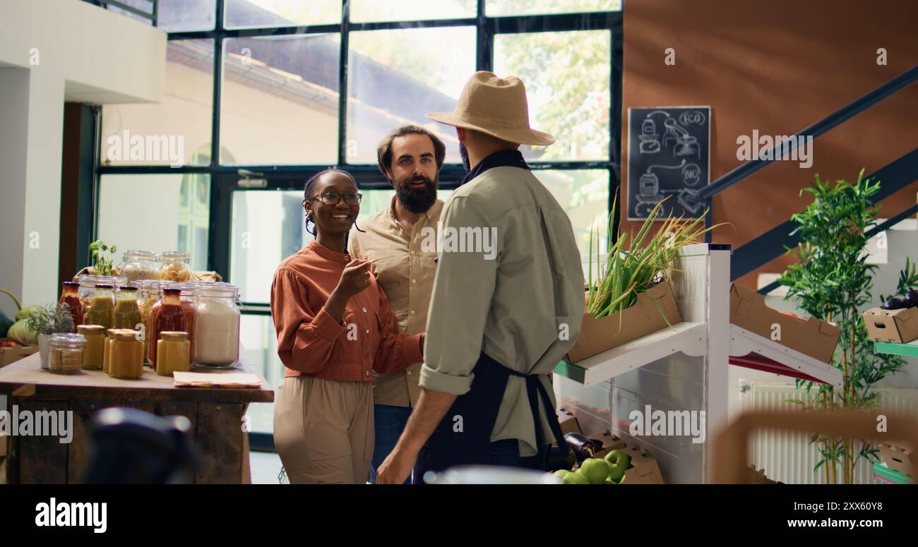 Couple asking seller about products in organic natural supermarket ...