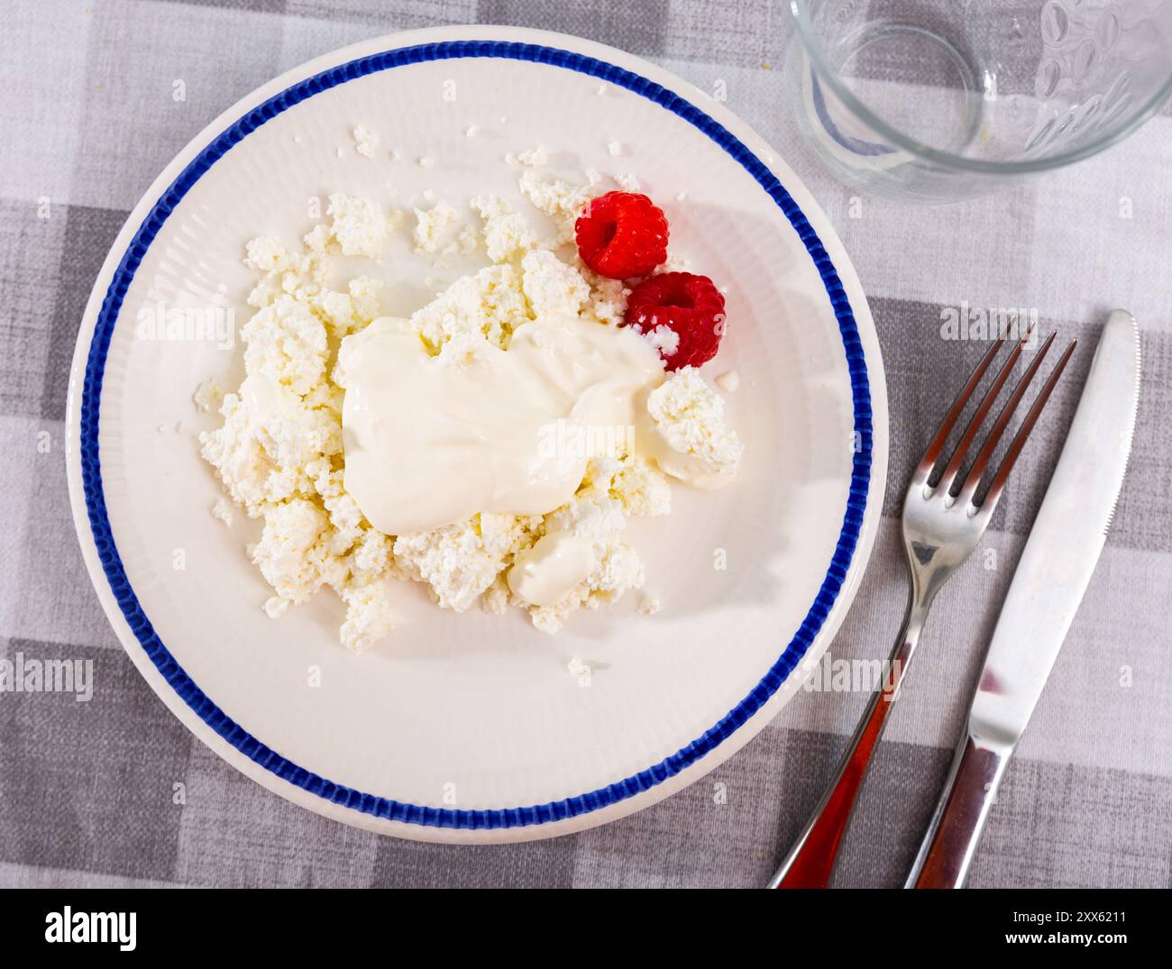 Cottage cheese mato with fresh raspberry and sour cream on ceramic ...