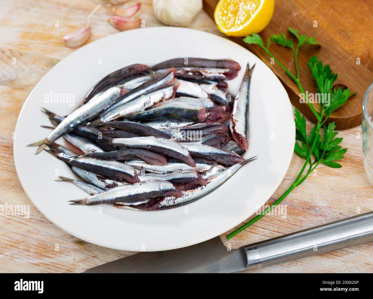 Pile of small raw fish is piled on plate, ready for frying Stock Photo ...