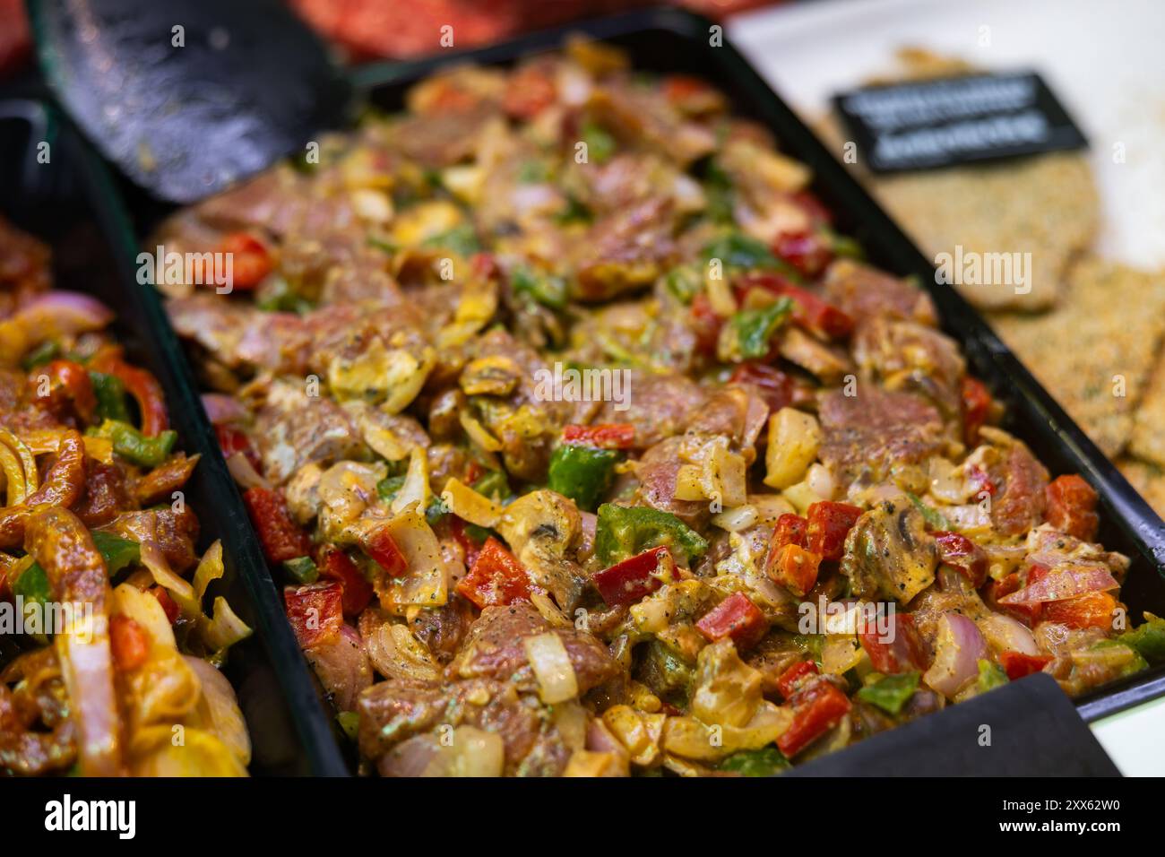 Marinated lamb with vegetables ready for stir-fry on store display ...