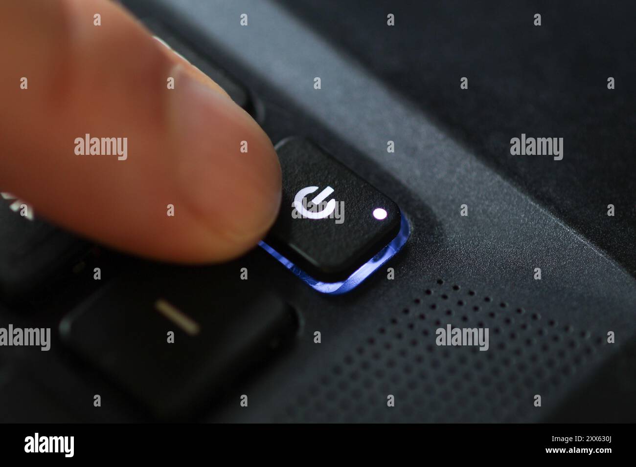 closeup of finger pushing power on button on laptop Stock Photo - Alamy