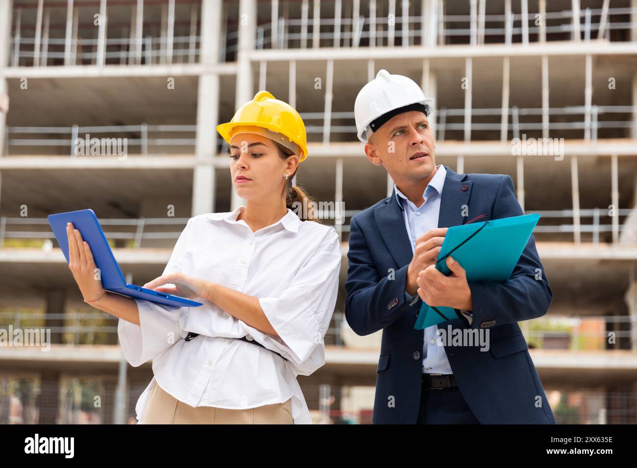 Two architects monitor the progress of work on the construction site ...