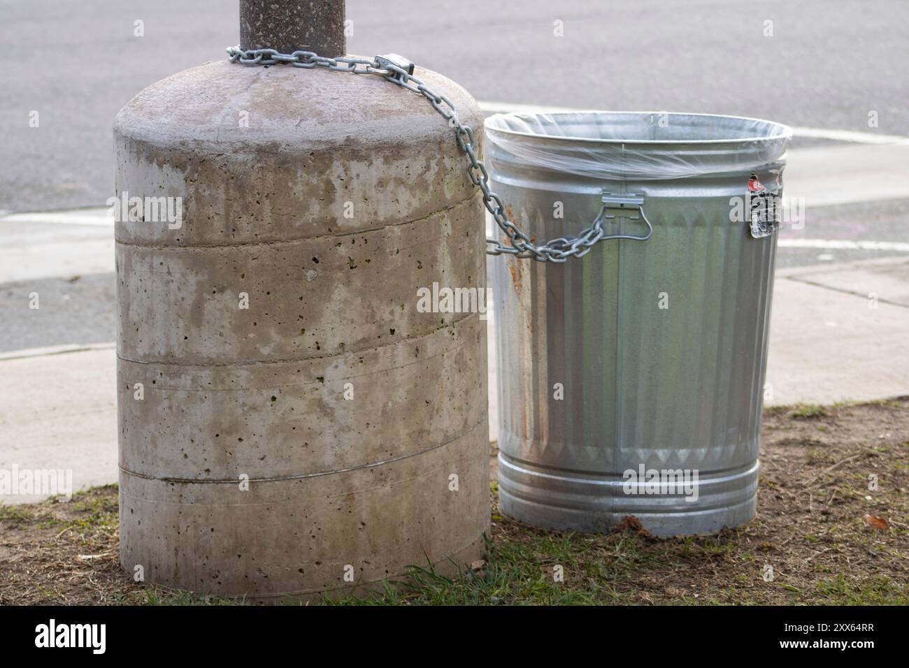 trash can chained to post Stock Photo - Alamy