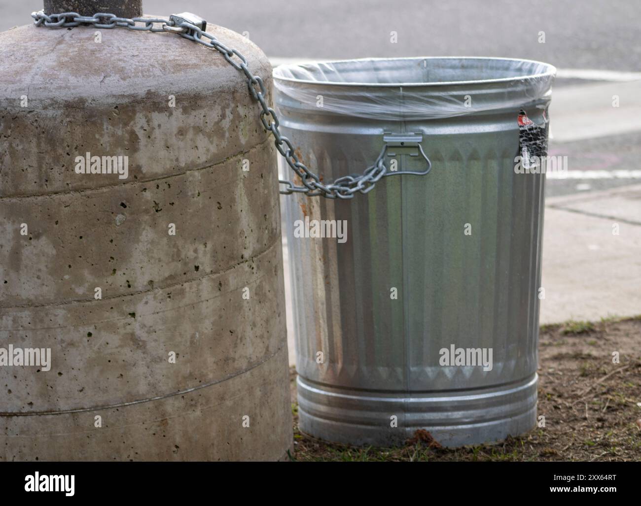 trash can chained to post Stock Photo - Alamy