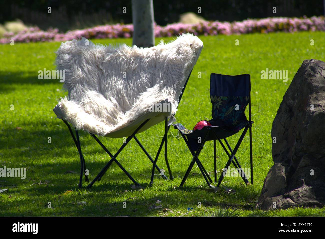 pink fuzzy folding chair next to child chair Stock Photo - Alamy