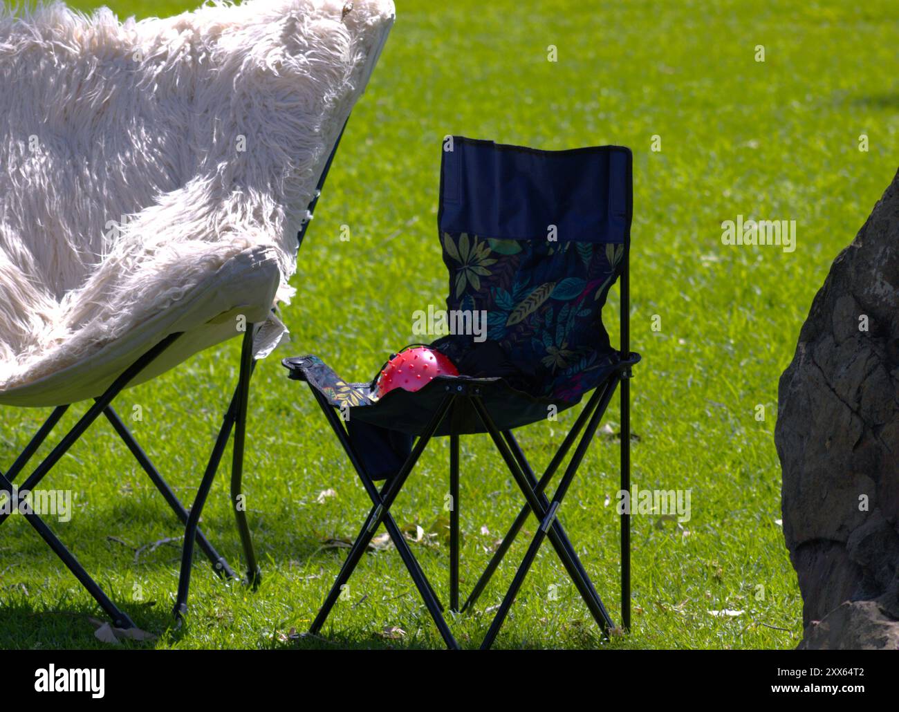 pink fuzzy folding chair next to child chair Stock Photo - Alamy
