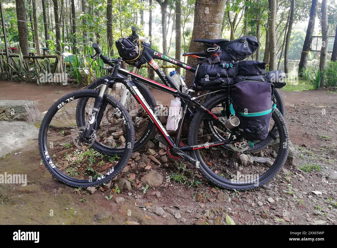 Mountain bike touring with pannier racks and saddlebag propped against ...