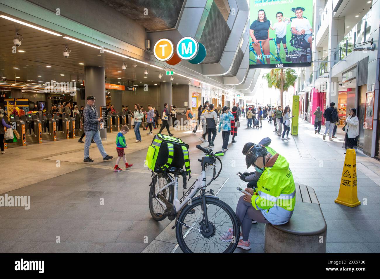 Uber Eats delivery riders take a break beside Sydney Chatswood ...