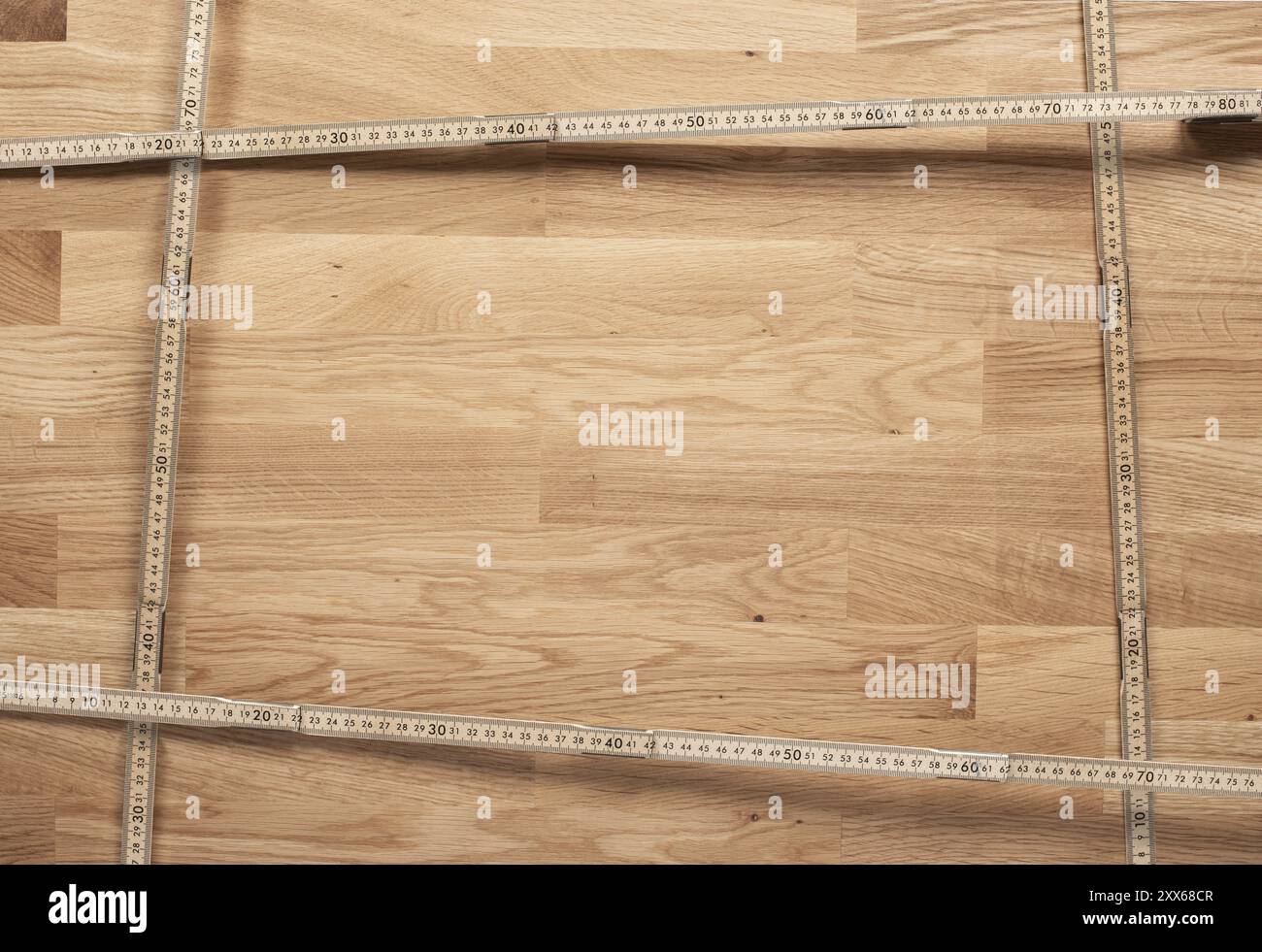 Wooden background with a frame of folding rulers Stock Photo - Alamy