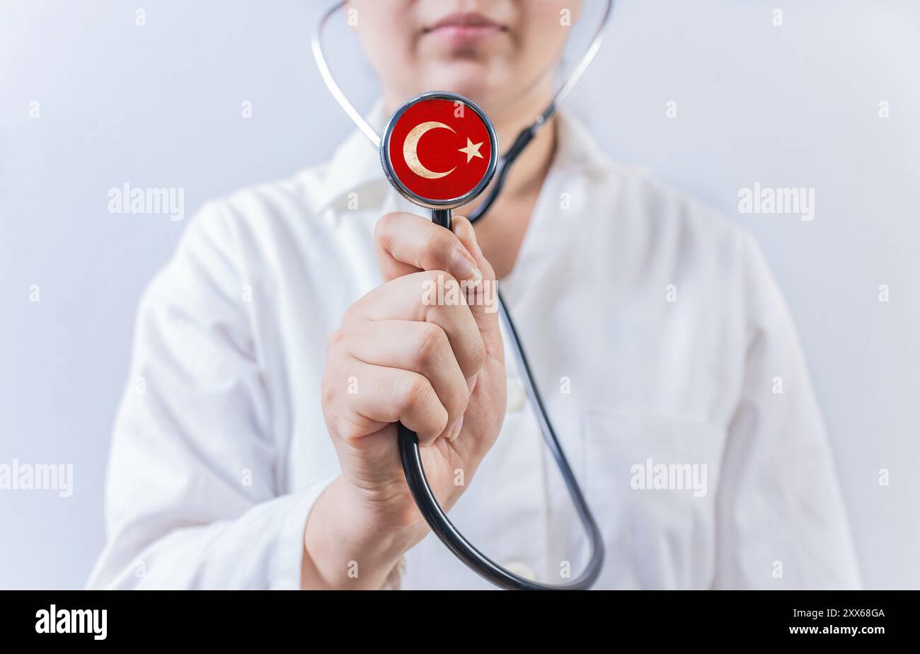 Female doctor holding stethoscope with Turkish flag. Turkiye Health and ...