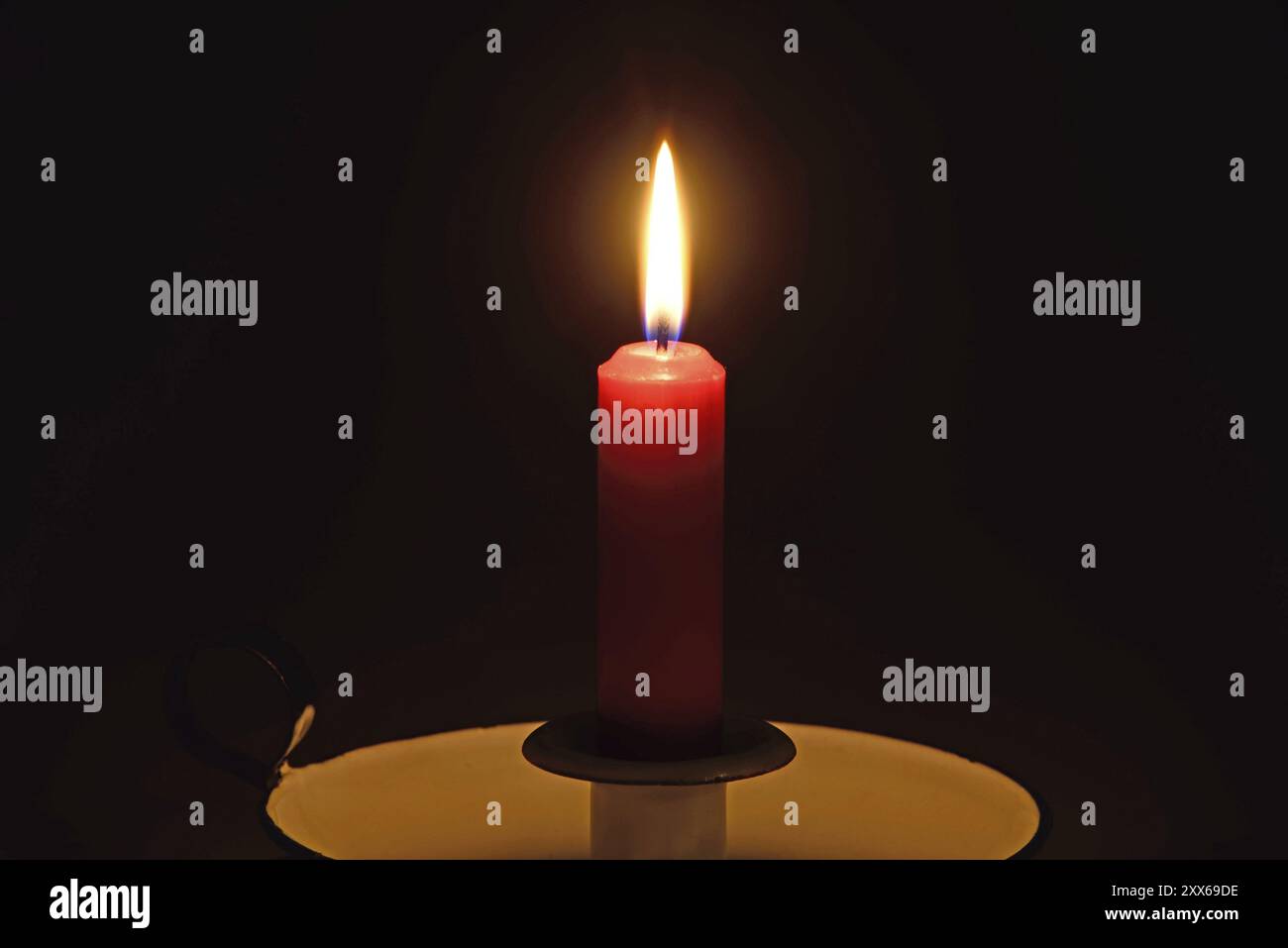Candlestick, burning red candle Stock Photo - Alamy
