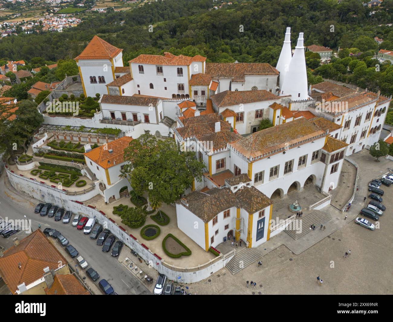 Overview of a historic castle with white towers and orange-red roofs ...