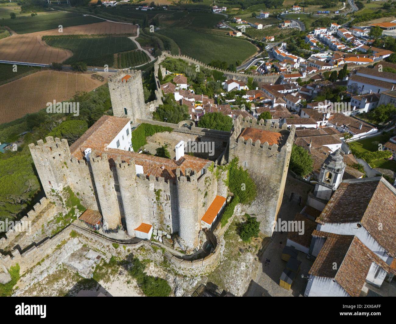 Aerial view of an imposing castle and a surrounding city wall enclosing ...