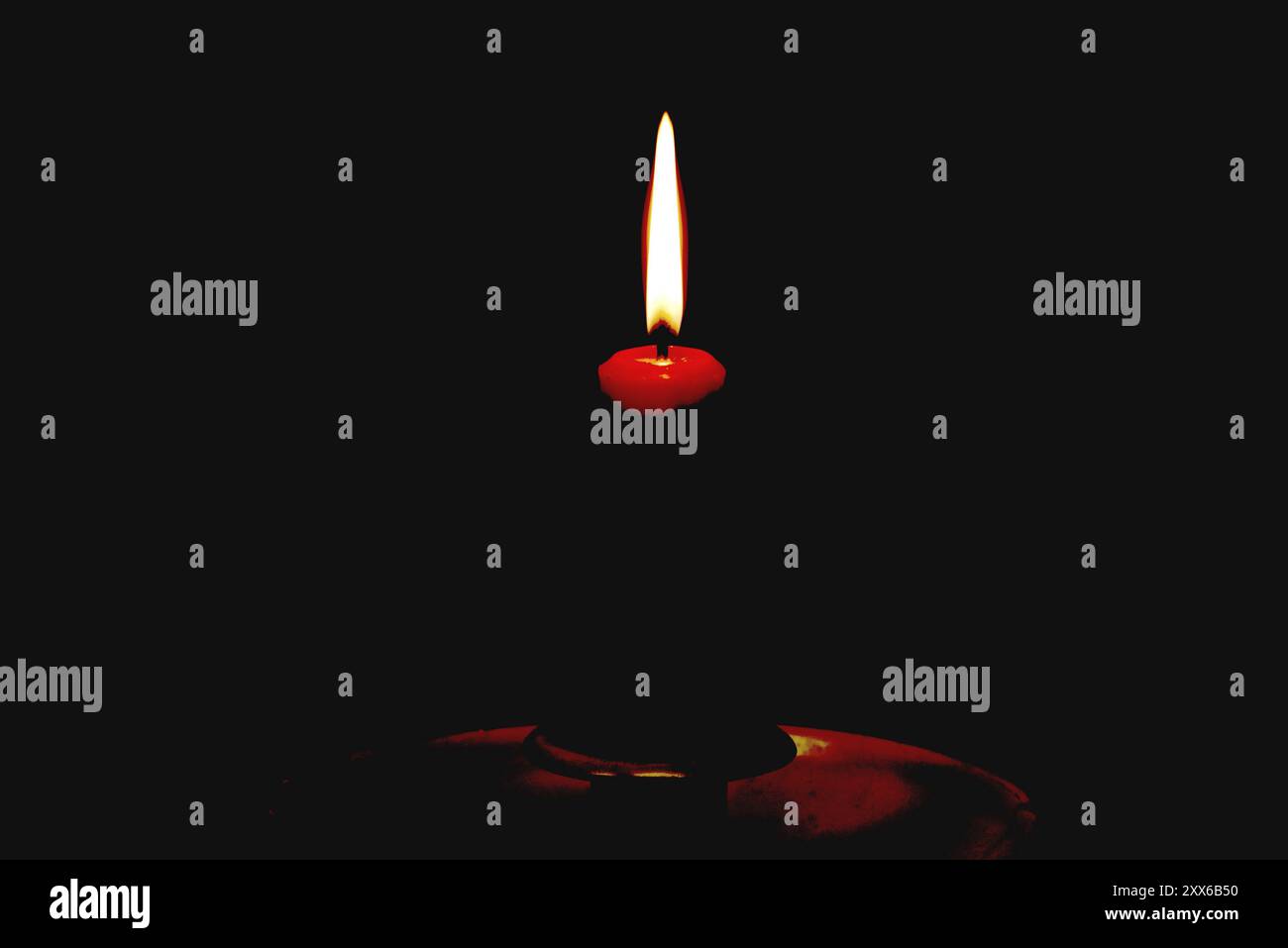 Candlestick, burning red candle Stock Photo - Alamy