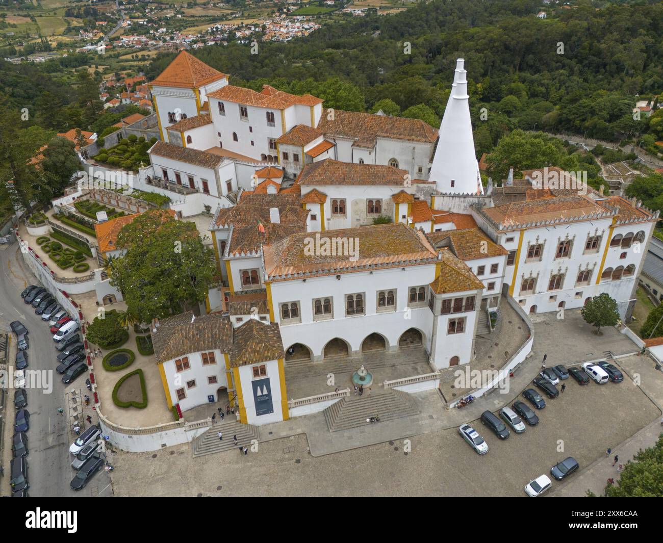 Aerial view of a historic castle with striking white towers and ...