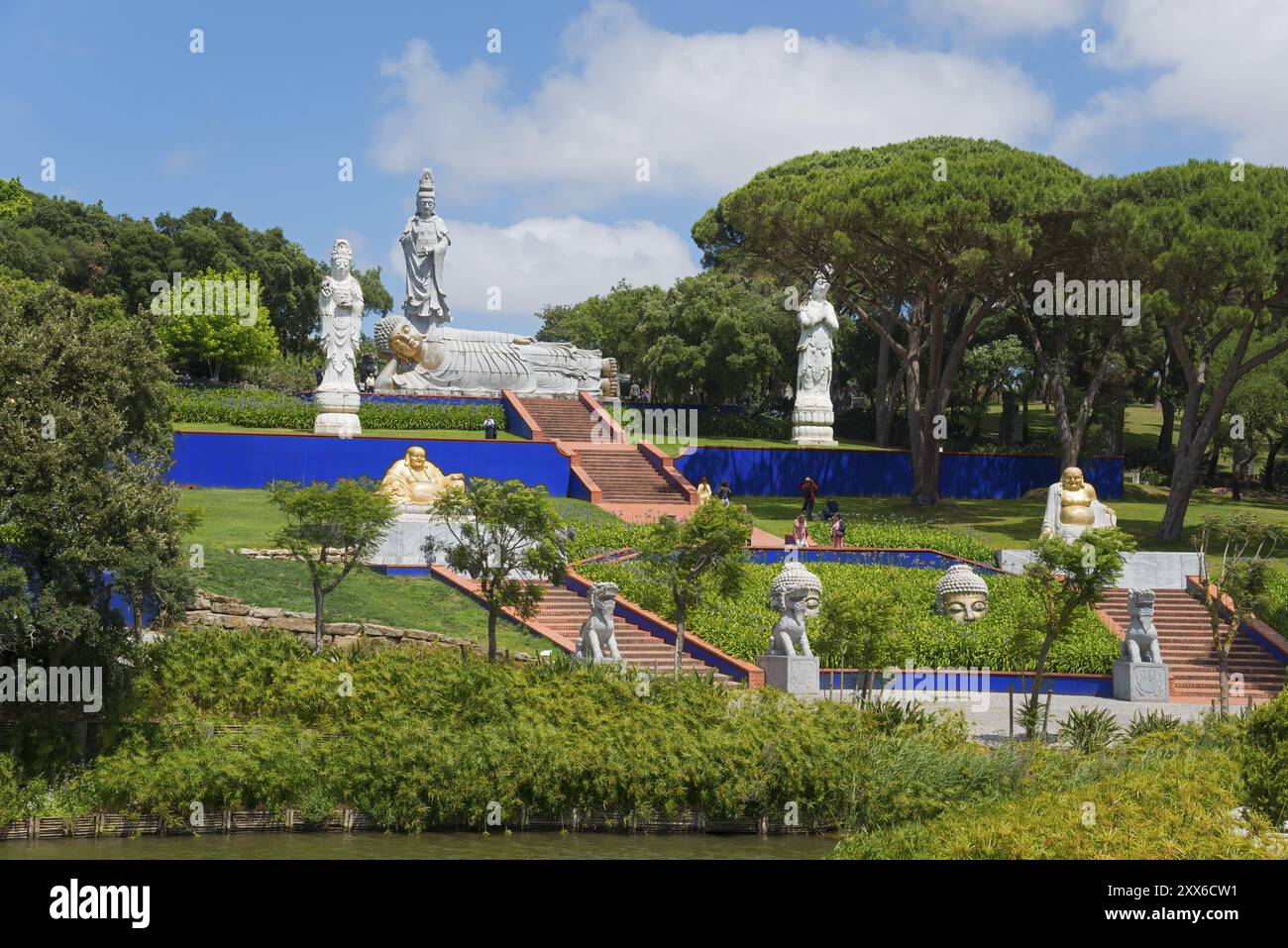 An extensive park with Buddha statues, stairs and lush green nature ...